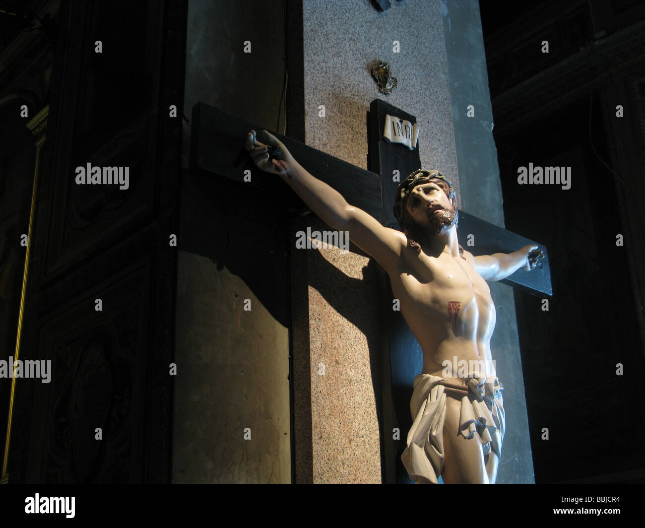 jesus on cross statue in church in rome italy Stock Photo - Alamy