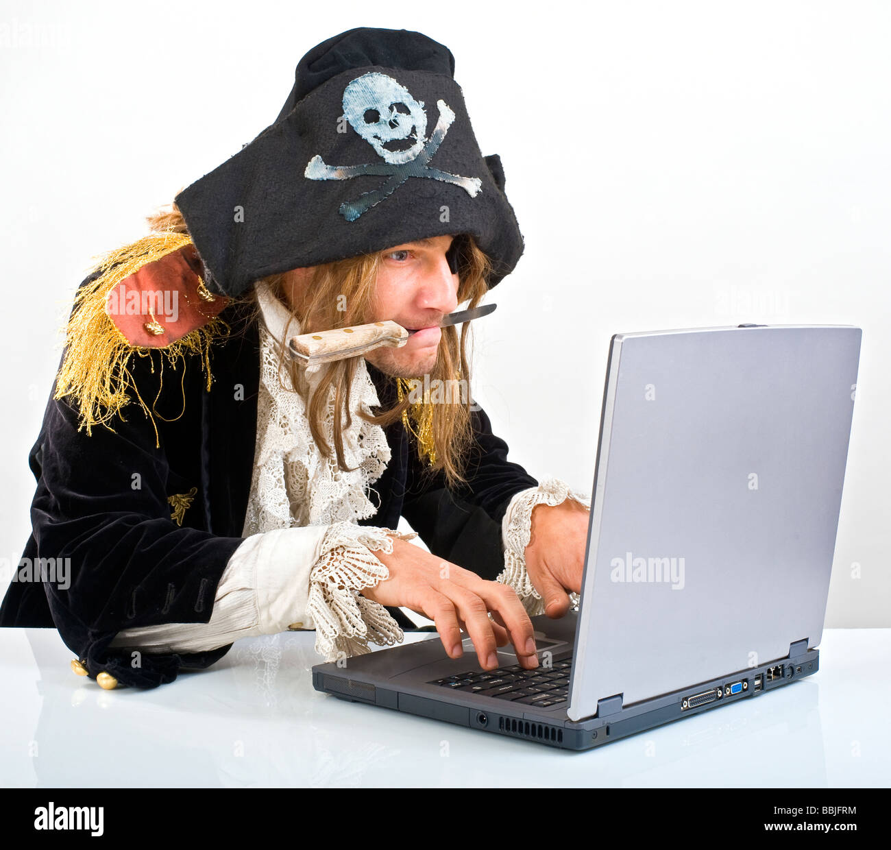 pirate attacking with a knife a laptop computer Stock Photo - Alamy