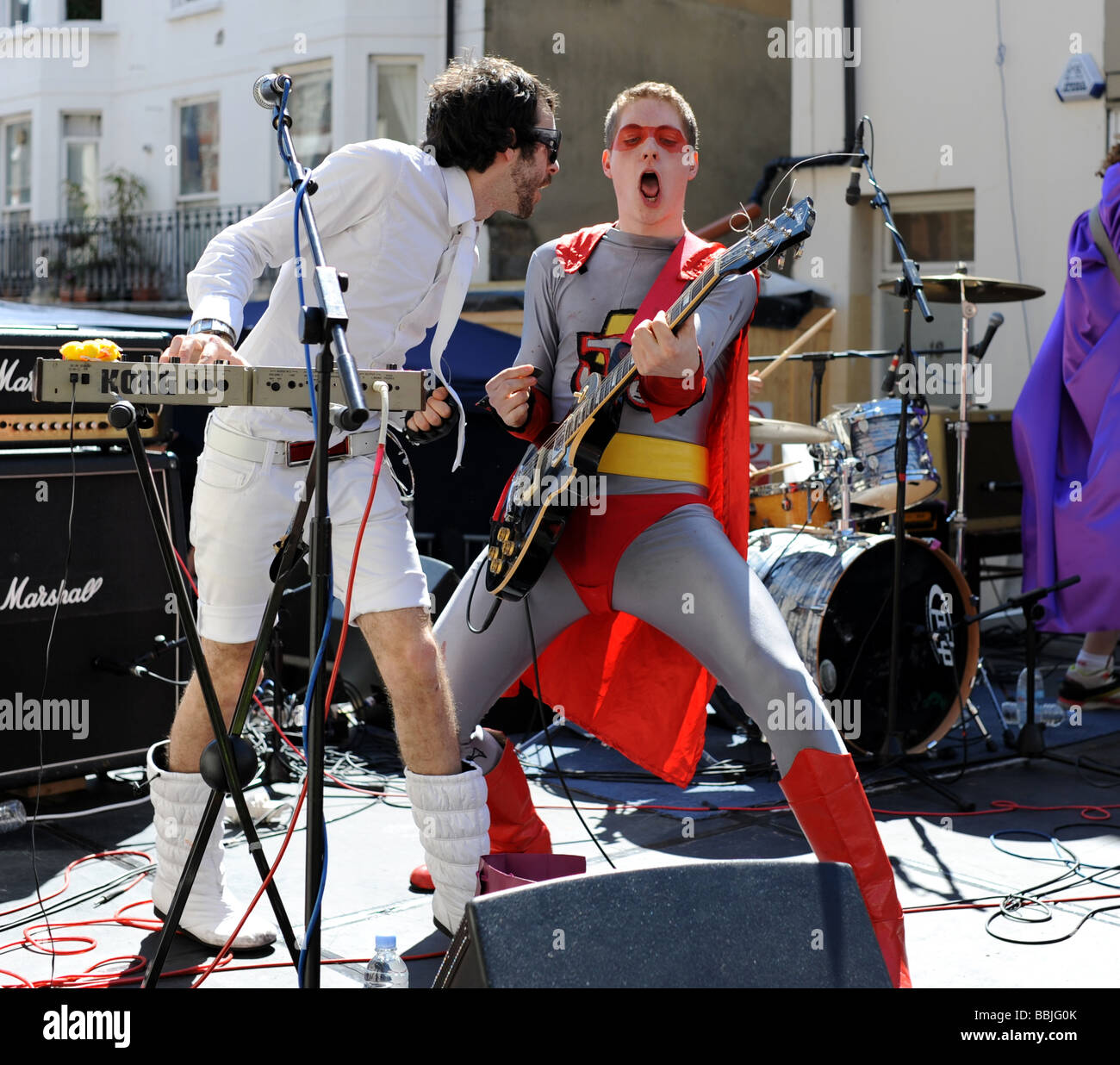 Rock band dressed as super heroes performing at the Sunflower Street ...