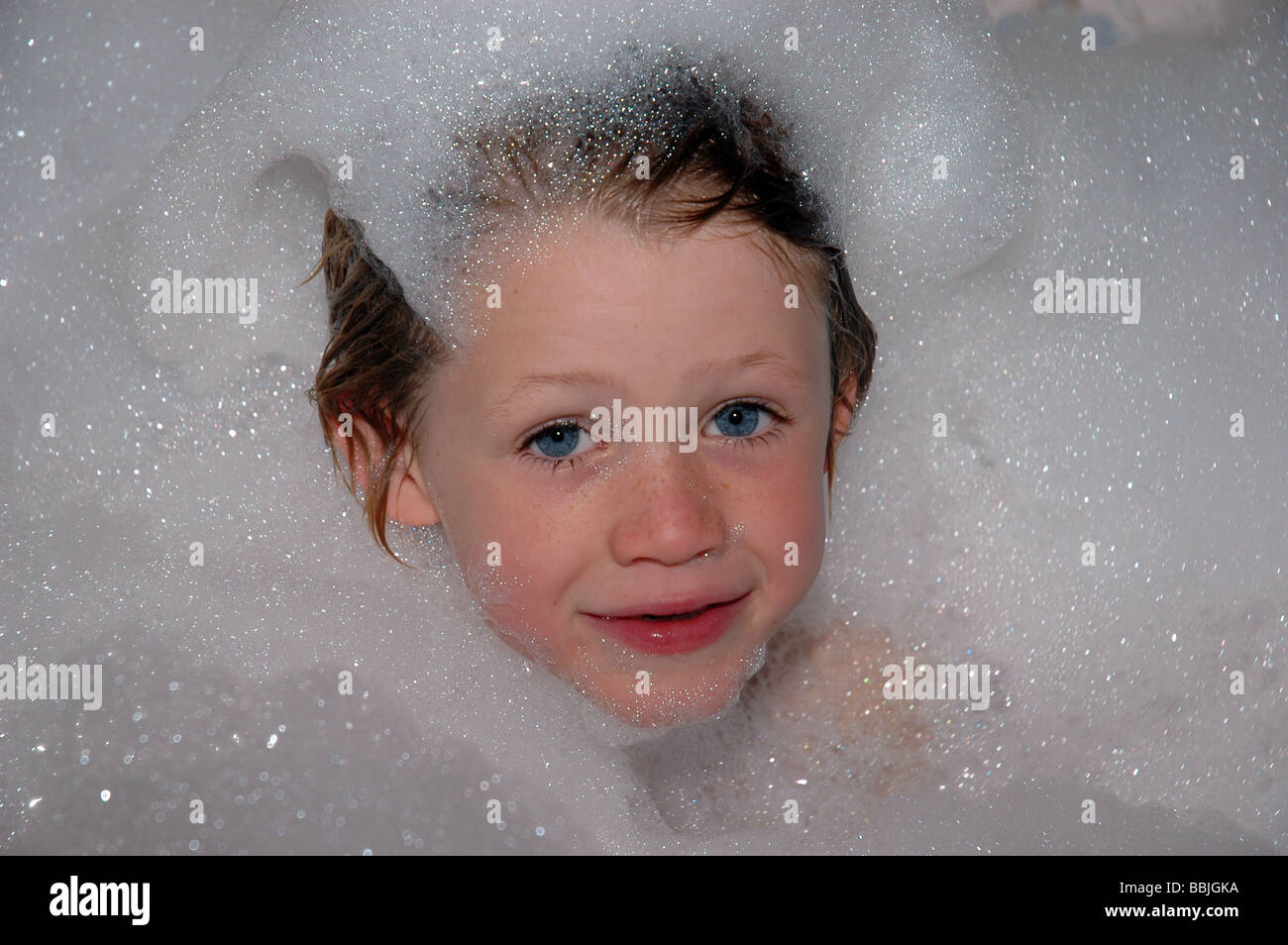 A young boy with blue eyes in a bubble bath Stock Photo - Alamy