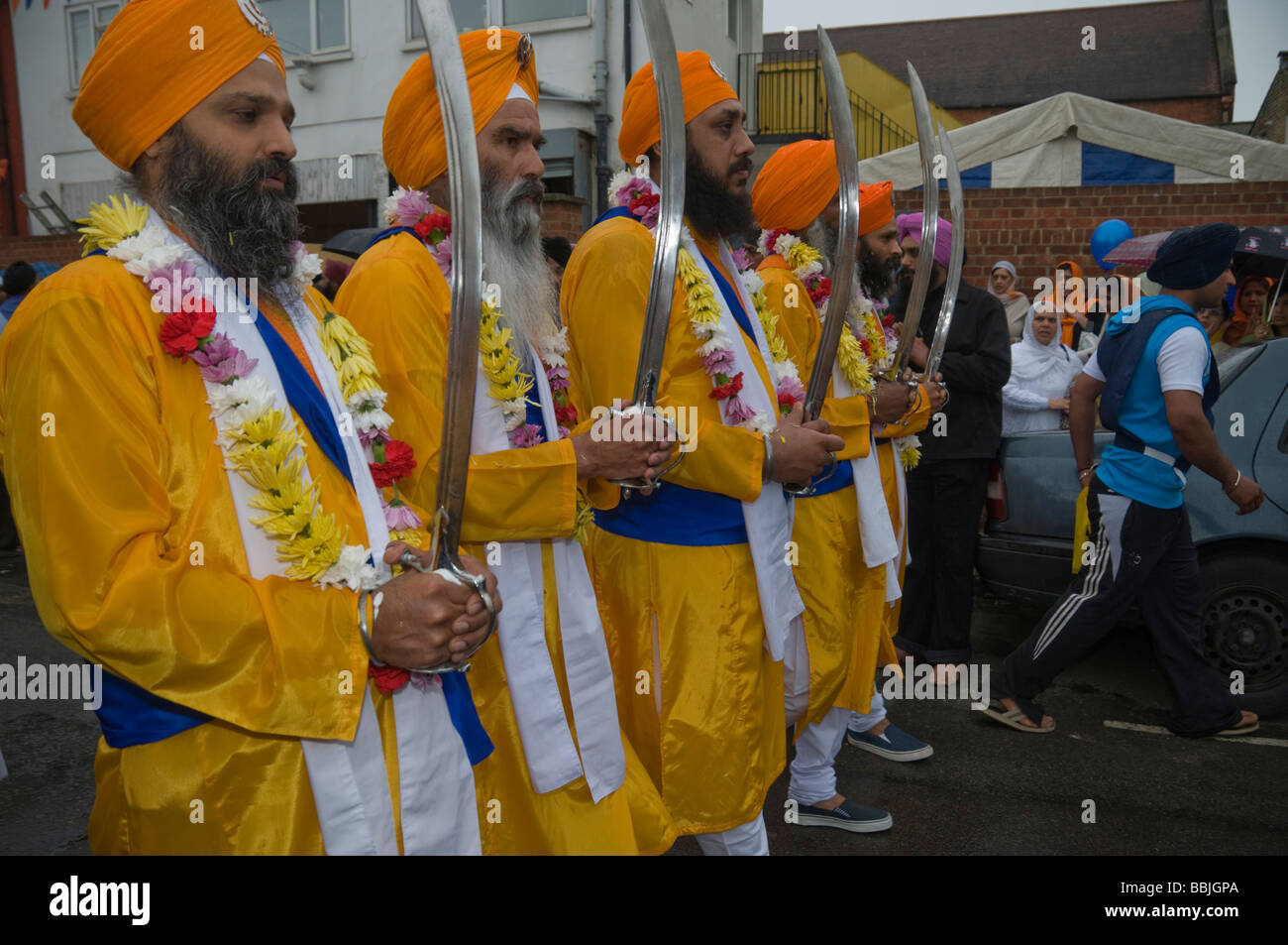 The Panj Piare (five beloved ones) in orange with swords held erect in ...