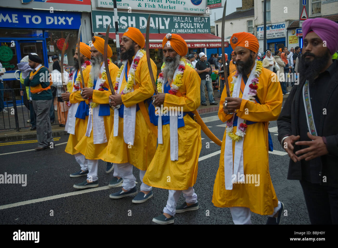 The Panj Piare (five beloved ones) in orange with swords held erect in ...