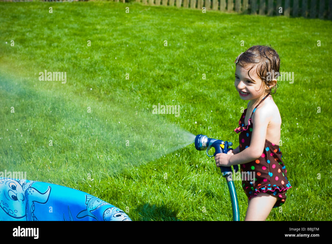Watering hose rainbow hi-res stock photography and images - Alamy