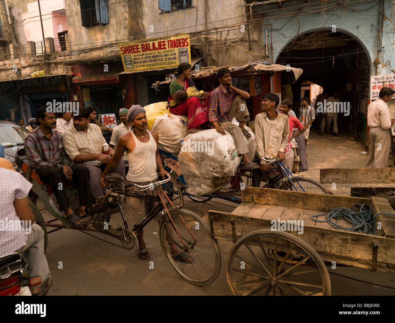 Man pushing bicycle through traffic in India Stock Photo - Alamy