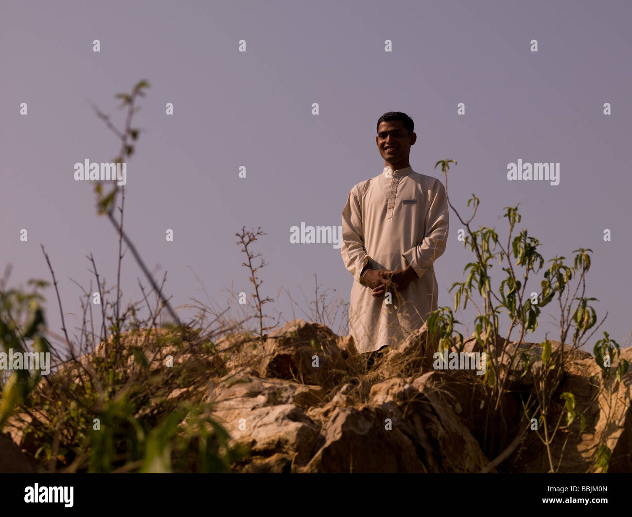 Man standing on hill in India Stock Photo - Alamy