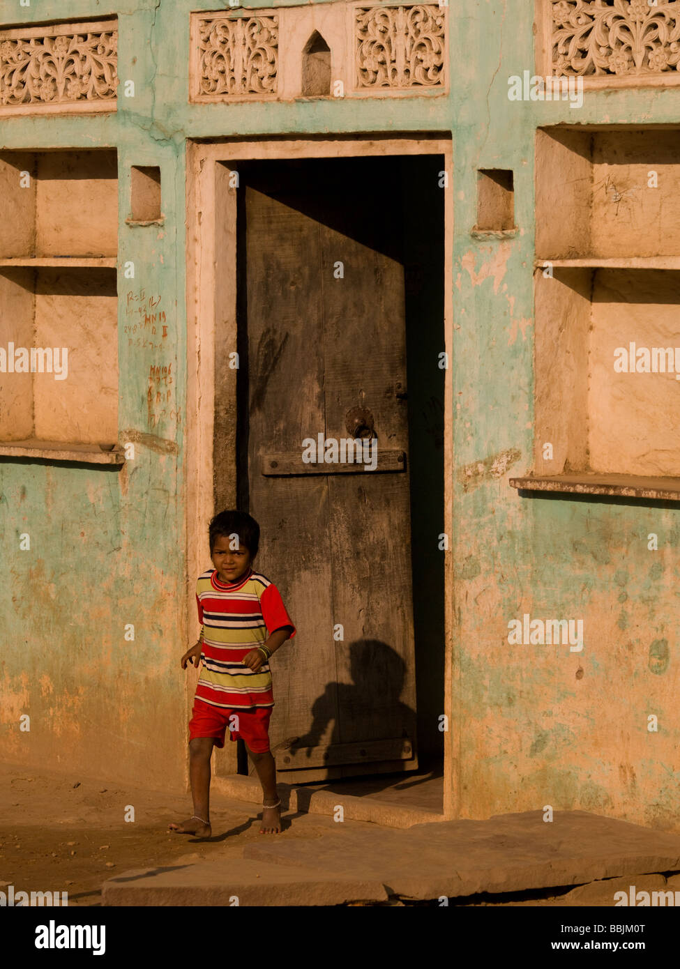 Boy coming out of building in India Stock Photo - Alamy
