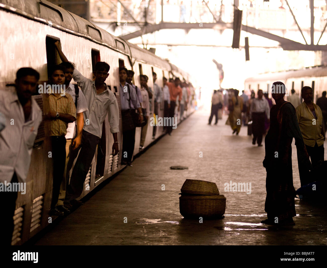 Men leaning out of train in India Stock Photo - Alamy