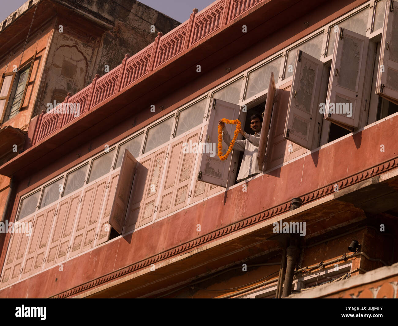 Man standing at a window in India Stock Photo - Alamy