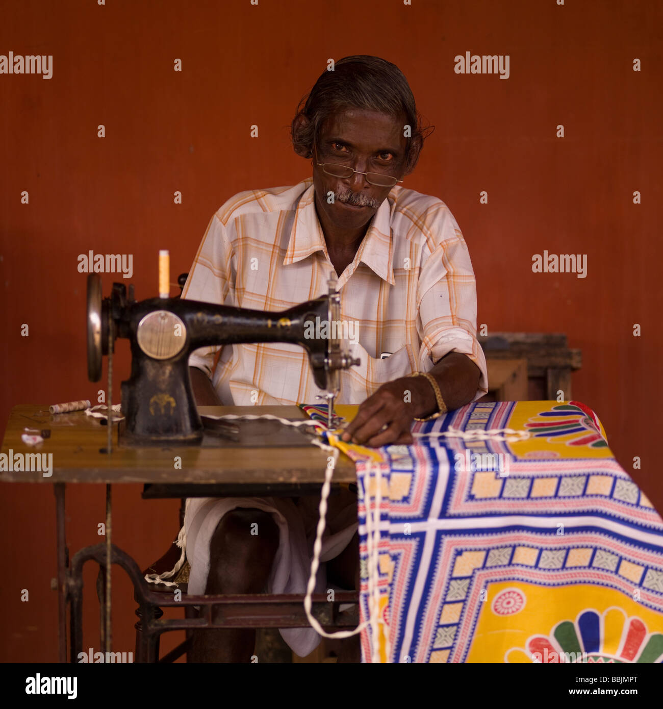 Man using a sewing machine in India Stock Photo - Alamy
