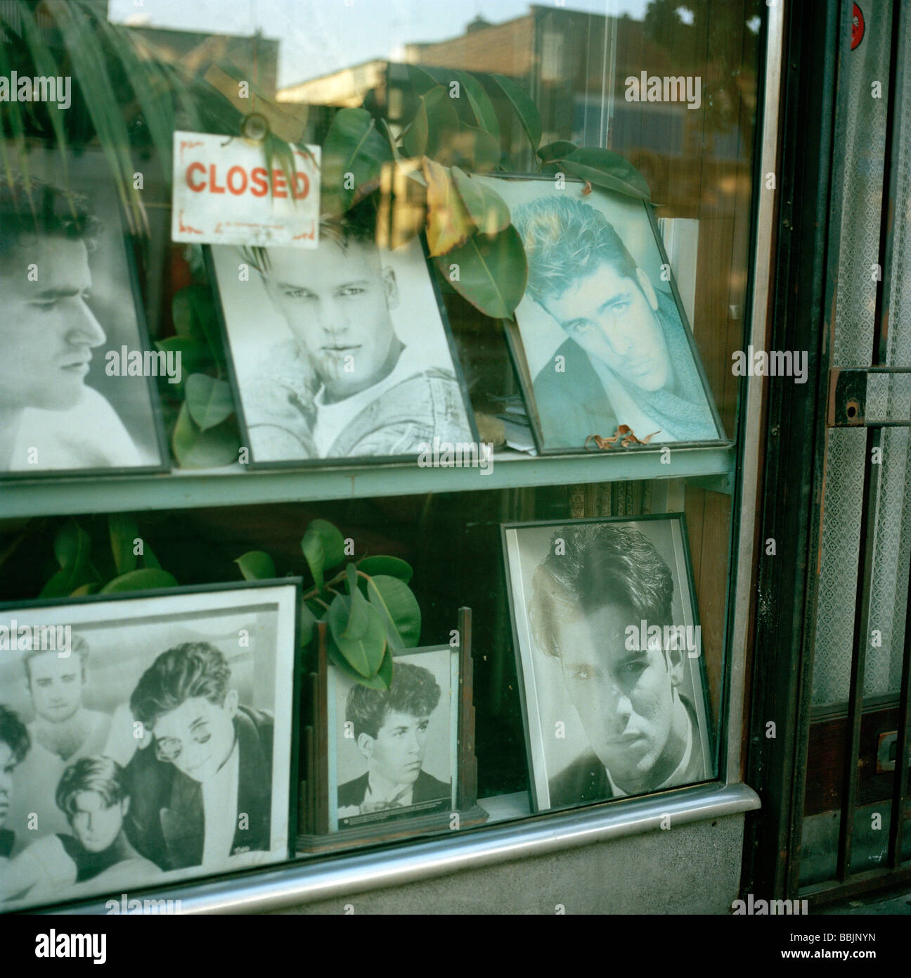 Old photographs in a window display of a barber shop on Caledonian Road ...
