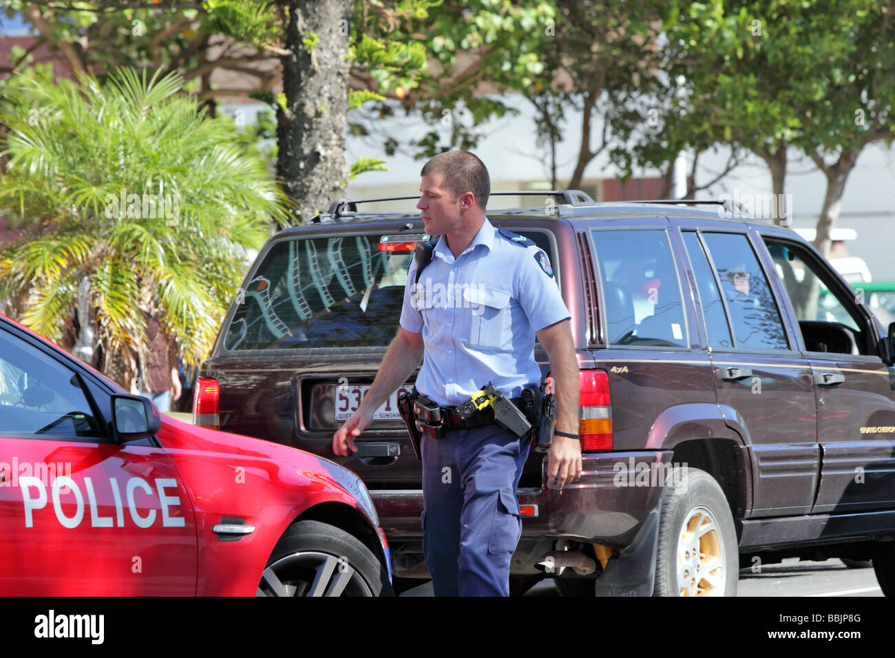 Police walk back from a traffic stop with taser on hip Stock Photo - Alamy