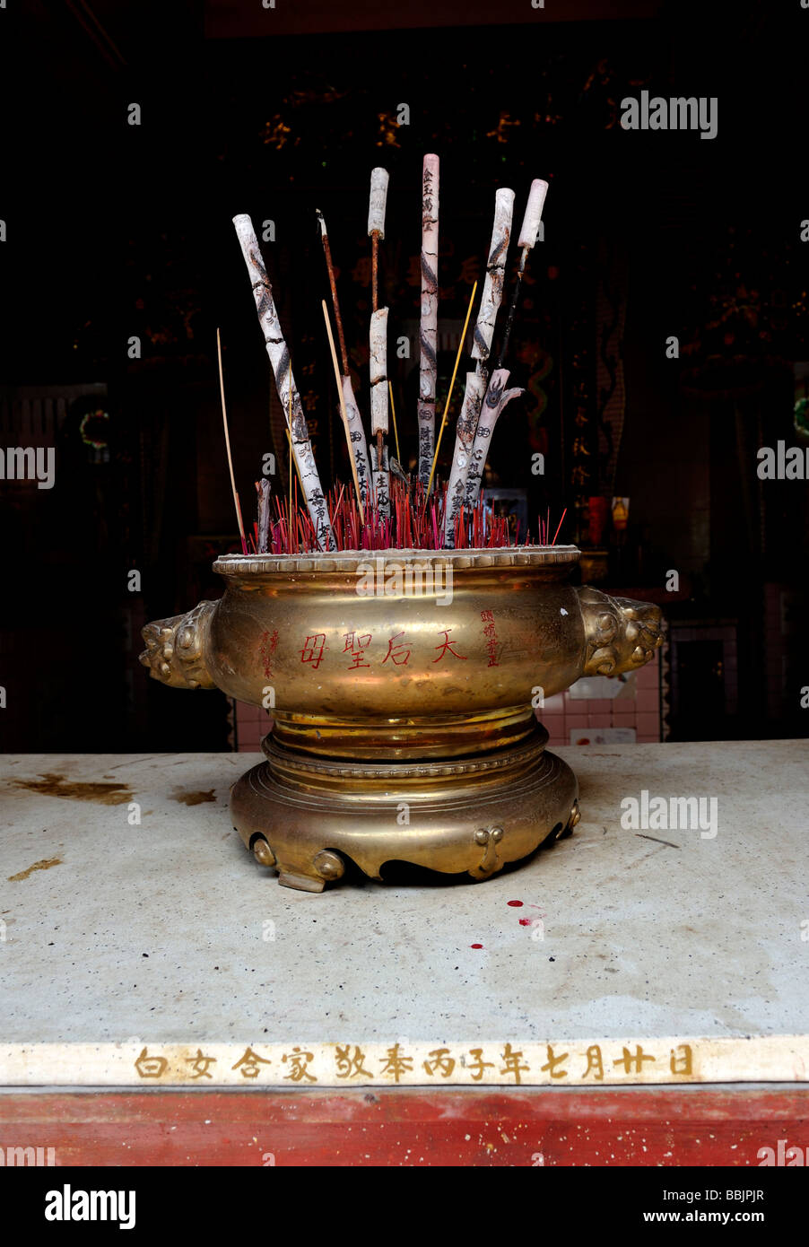 Incense urn with burnt remnants of large decorated incense sticks. Cao ...