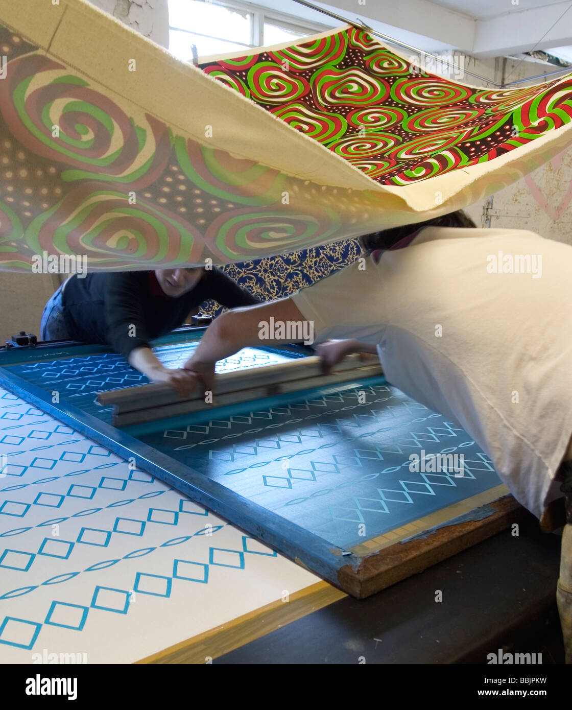 two workers screen printing in workshop creative materials pattern ...