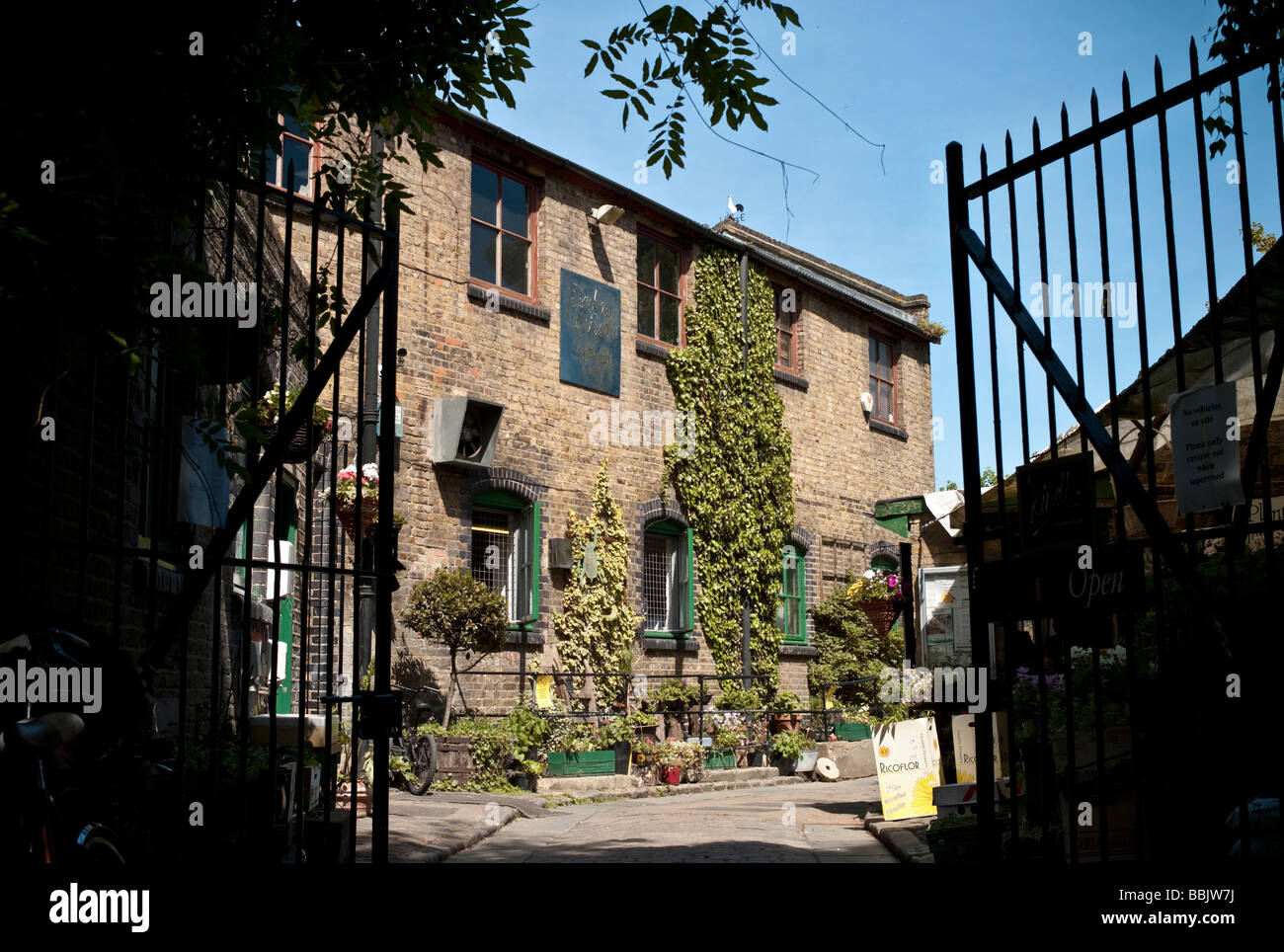 View through the gates of the main brick building at Hackney City Farm ...
