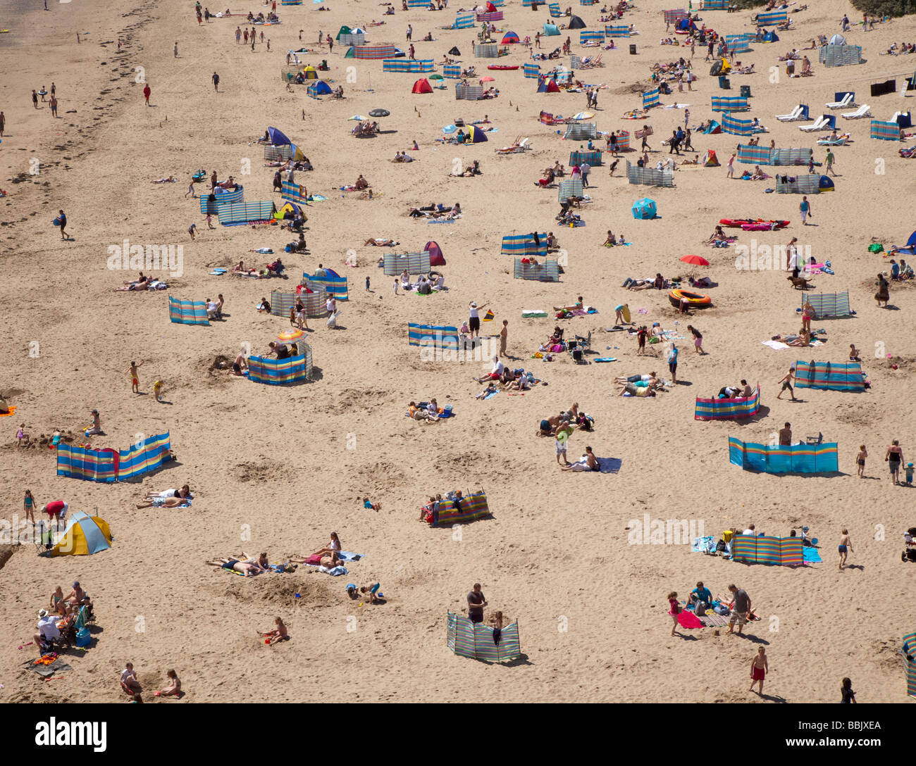 Sun bathers on the South beach at Tenby in Pembrokeshire, South Wales ...