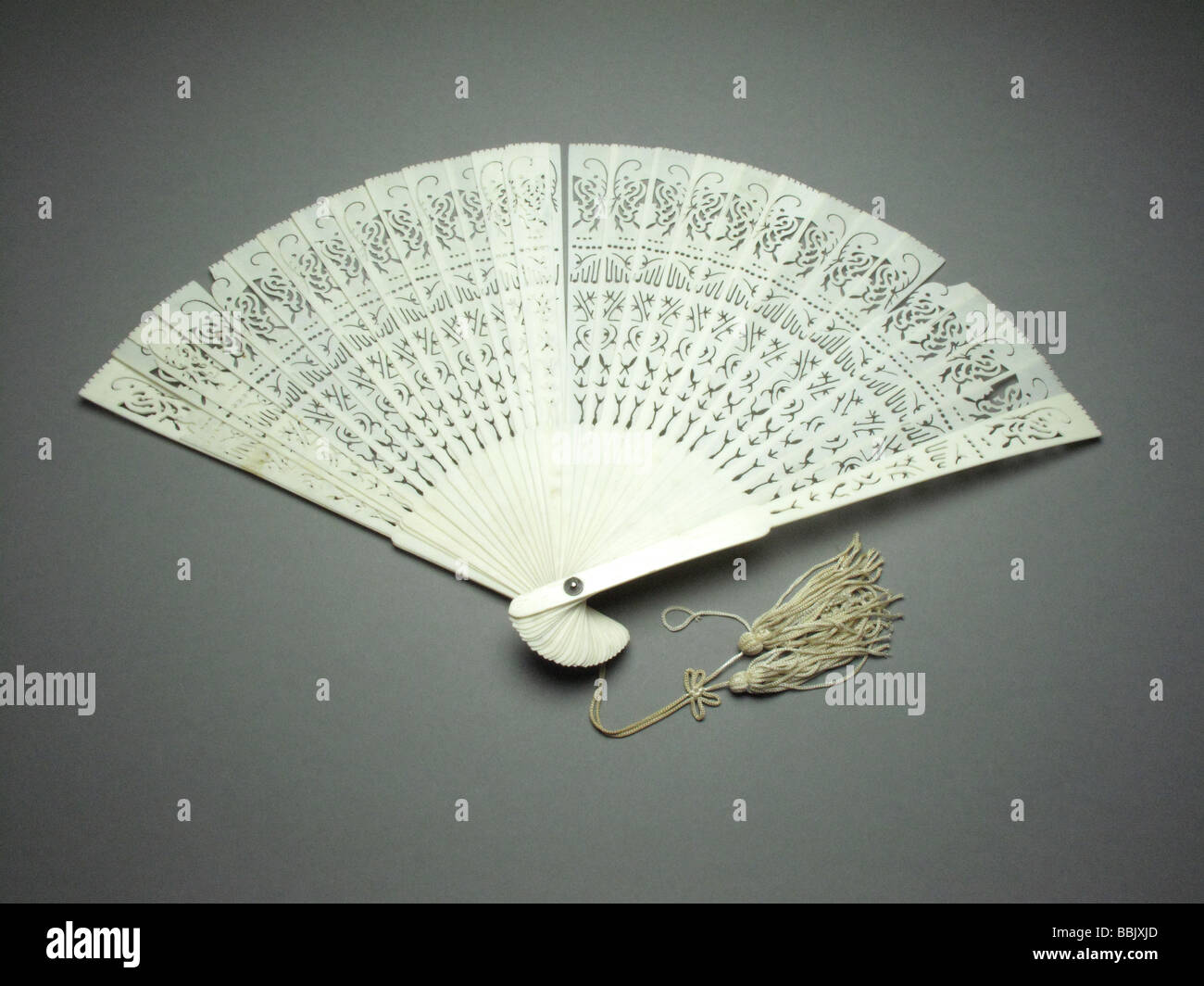 Antique Chinese bone fan with silk carrying cord Stock Photo - Alamy
