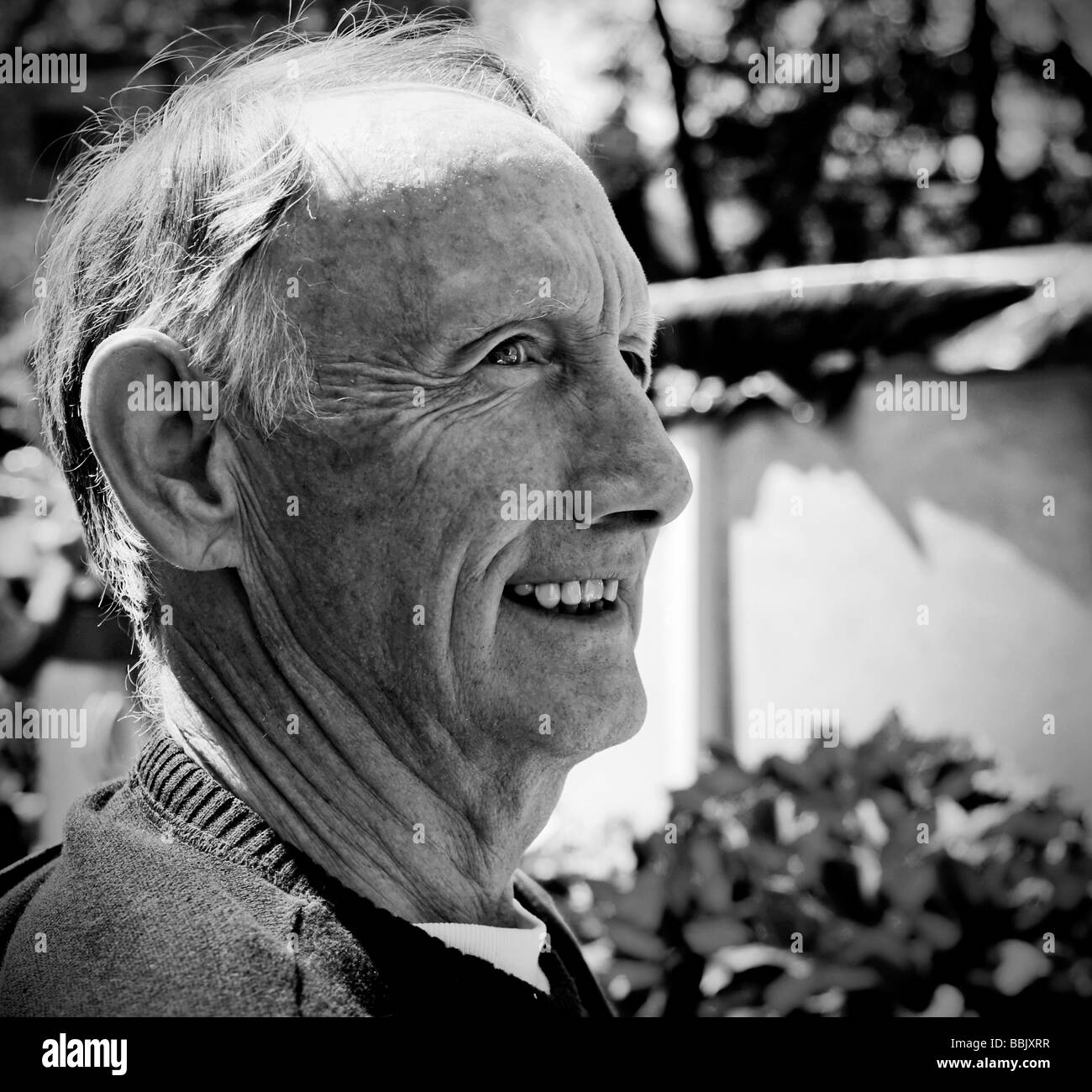 Happy senior smiling in sunshine Stock Photo - Alamy