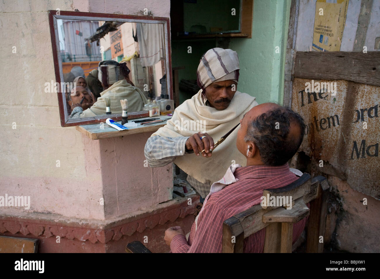 Ganges River, Varanasi, India; Barber shaving customer Stock Photo - Alamy