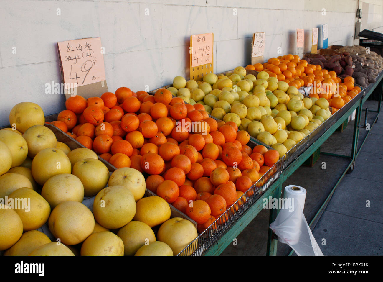 Grapefruit and oranges on display for sale at local neighborhood marke ...
