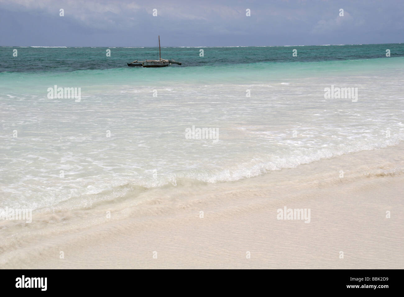A small dhow lying just off the shore on Zanzibar Stock Photo - Alamy