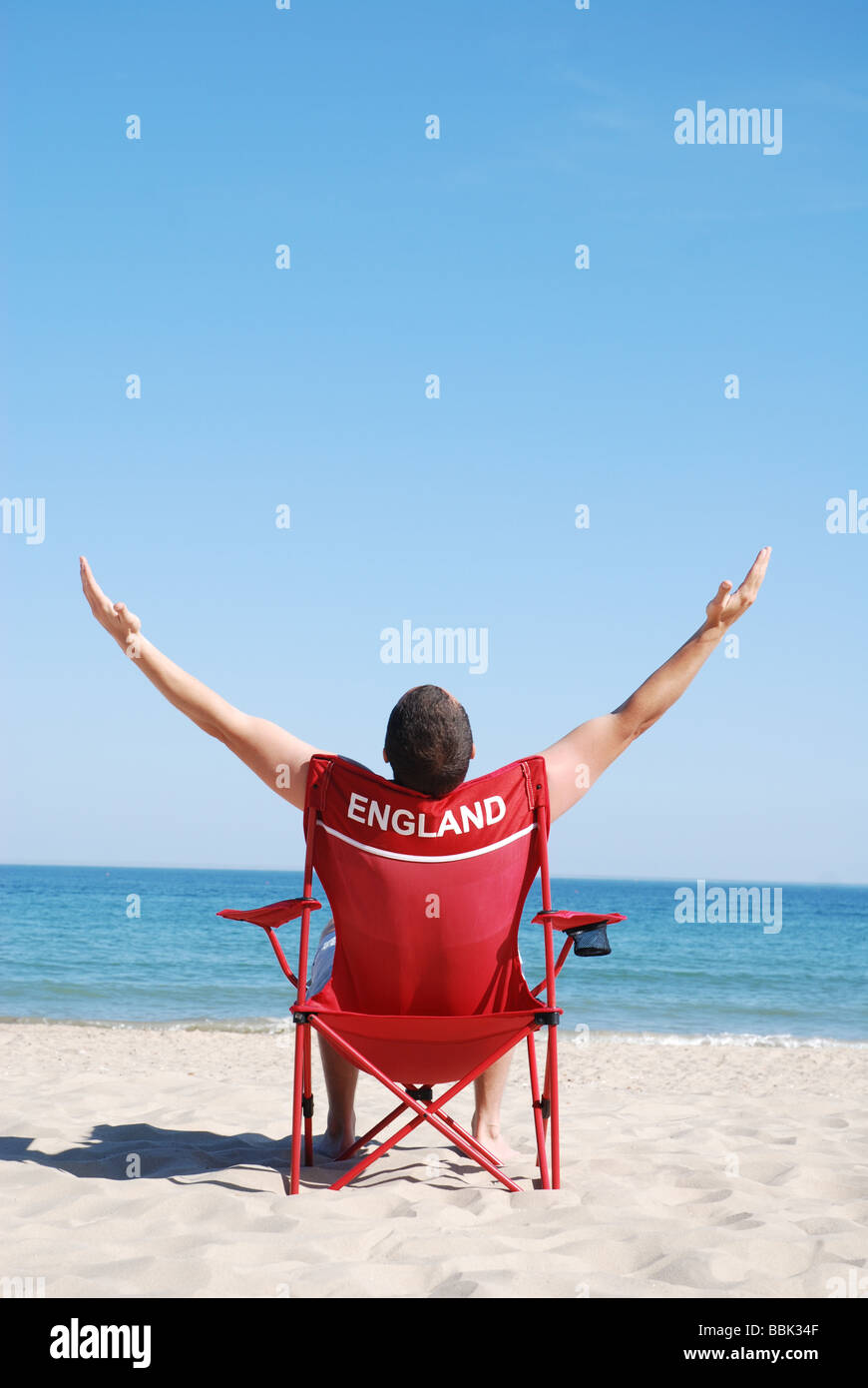 Man on deckchair at the beach Stock Photo - Alamy