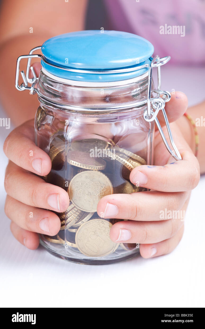 childs hands around a jar full of coins Stock Photo - Alamy