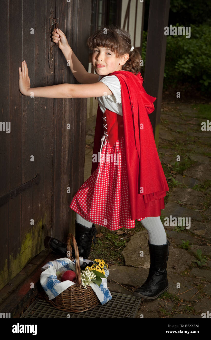 Little red riding hood entering the cottage of her grandmother Stock ...