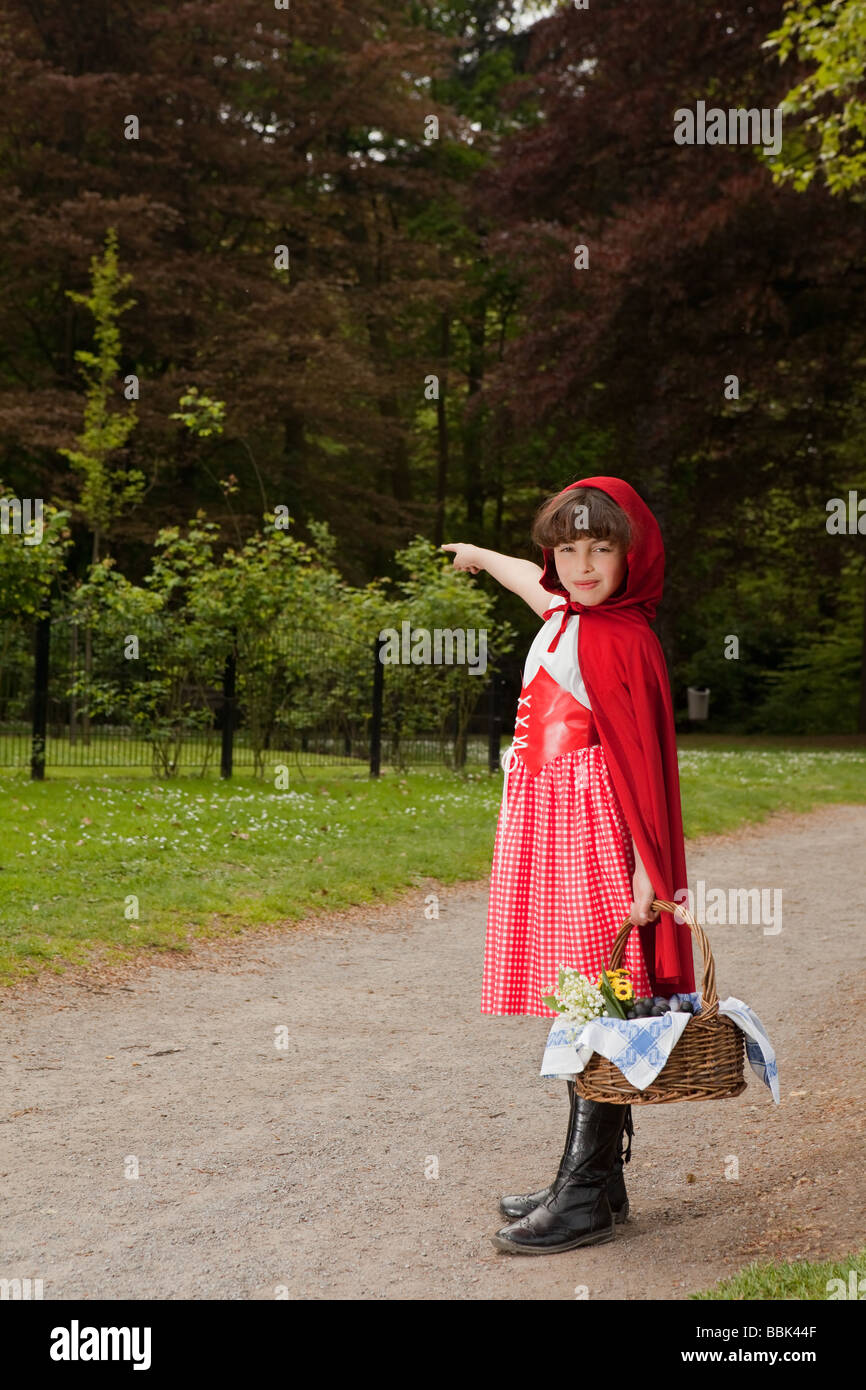 Little red riding hood pointing at her grandma s cottage Stock Photo ...