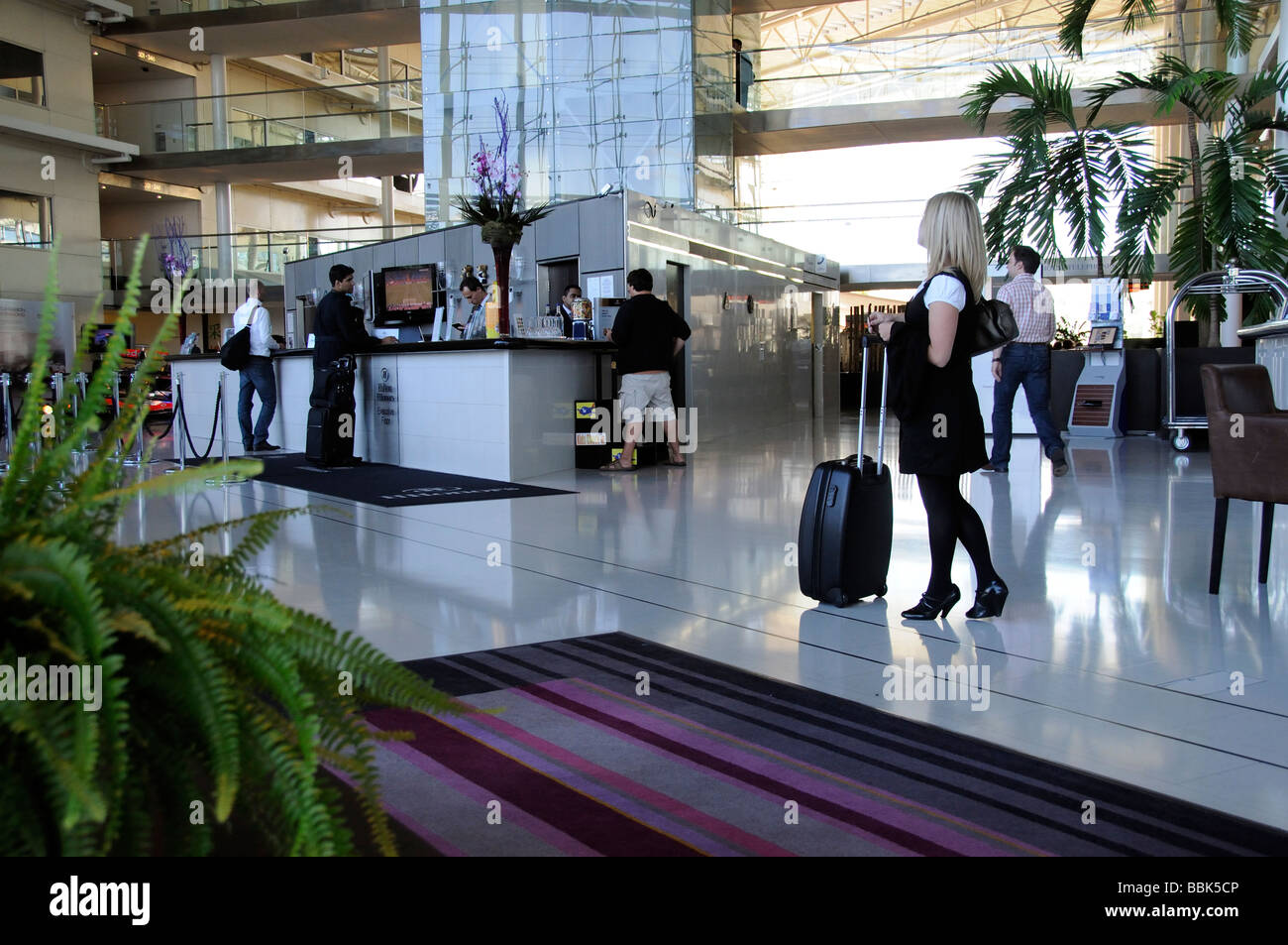 Hotel lobby reception and check in desk woman dressed in black with a ...