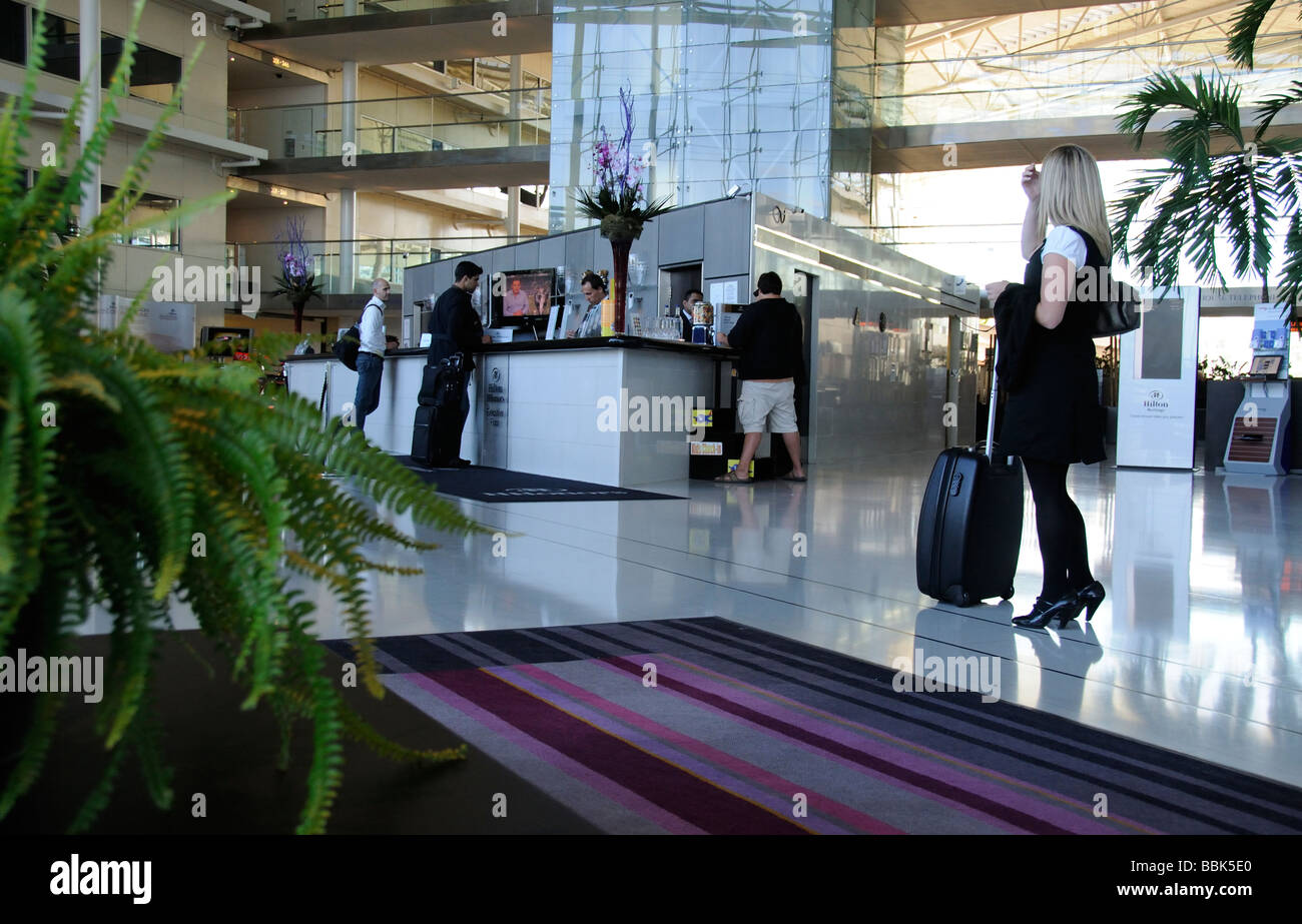 Hotel lobby reception and check in desk woman dressed in black with a ...