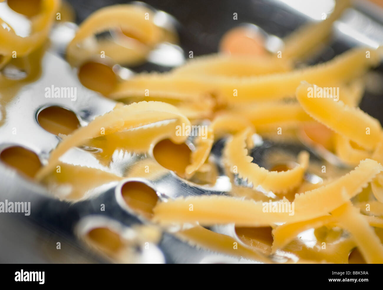 A close up of cheese being grated Stock Photo - Alamy