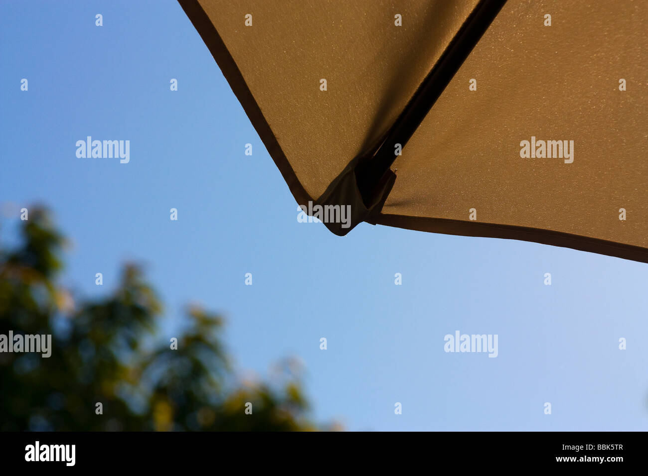 Corner of a Parasol against blue sky Stock Photo - Alamy