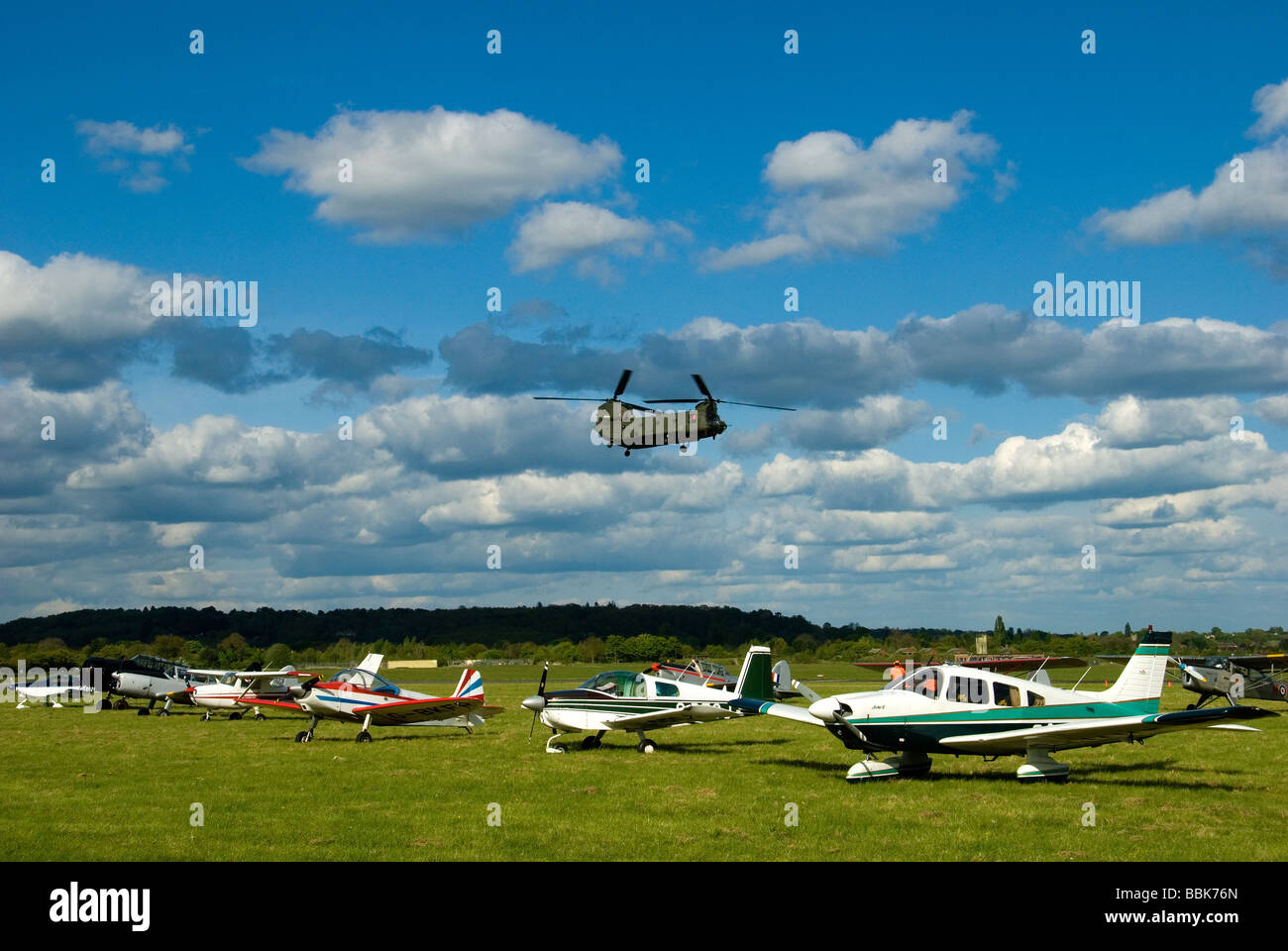 A chinook Helicopter overflying some light aircraft Stock Photo - Alamy