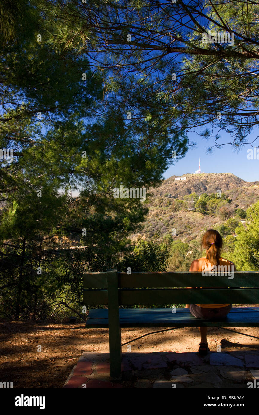 A hiker stops to look at the Hollywood sign from the Mt Hollywood Trail ...