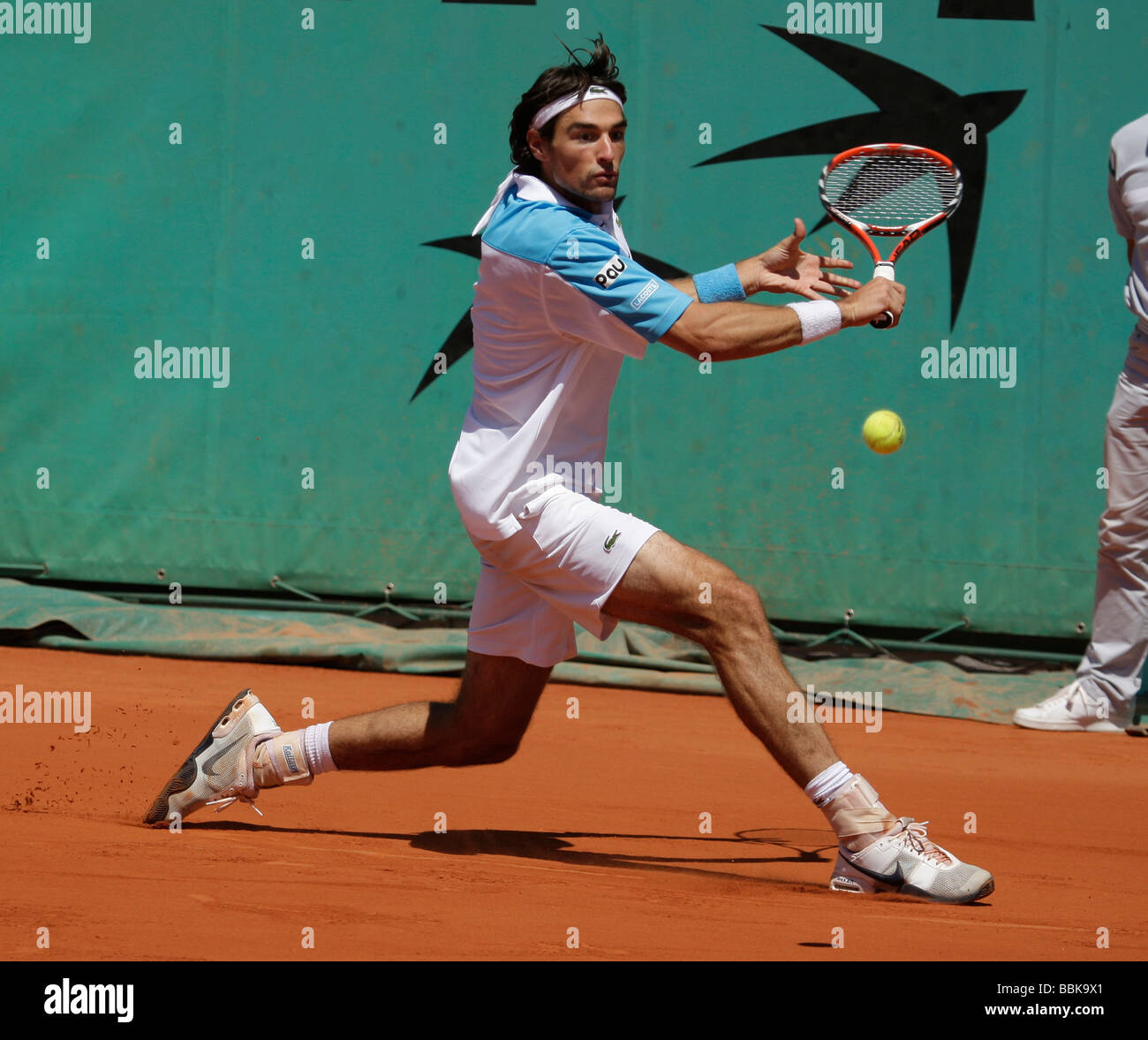 Tennis player Jeremy Chardy (FRA) plays a backhand return at Roland ...