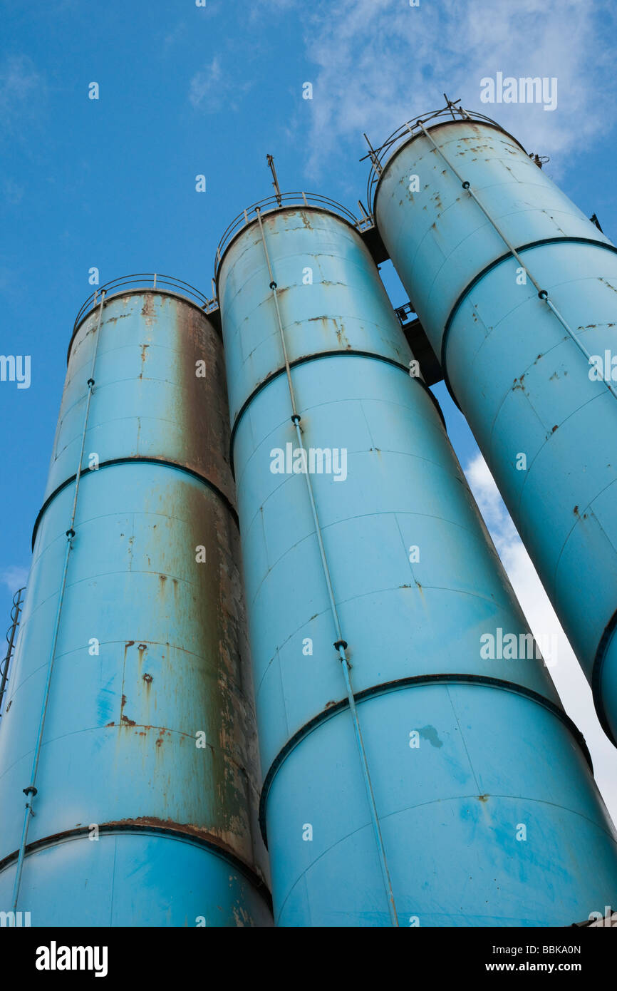 Three blue rusty silos against blue sky Stock Photo - Alamy