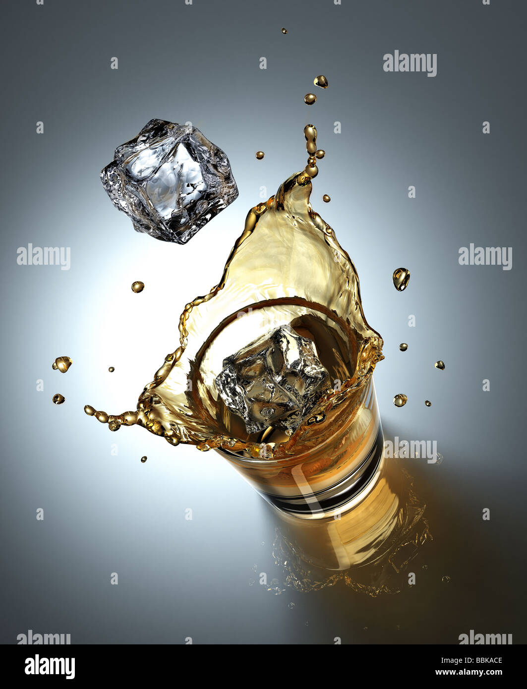 ice cube splashing in a glass full of liquid Stock Photo - Alamy