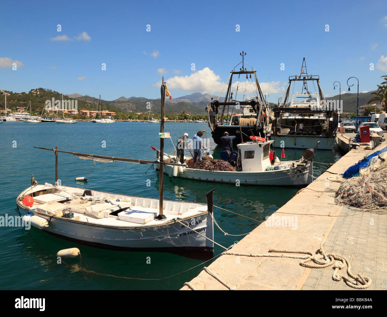 Fishermen sorting their nets in harbour at Port d Andratx in Mallorca ...