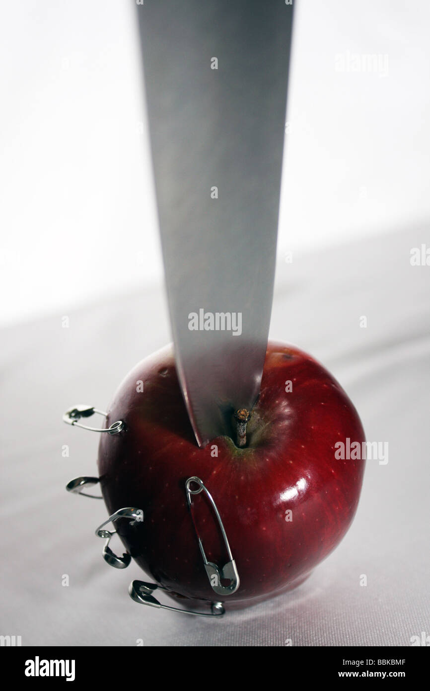 An unusual photograph of an apple with pins, safety pins and drawing ...