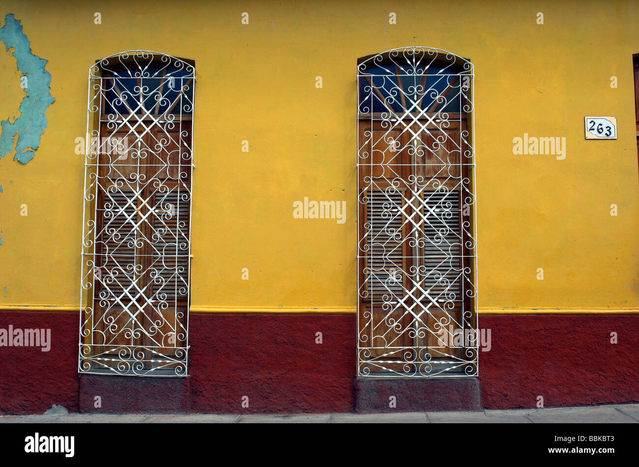 Colorful canary yellow facades with wrought iron windows in Trinidad ...