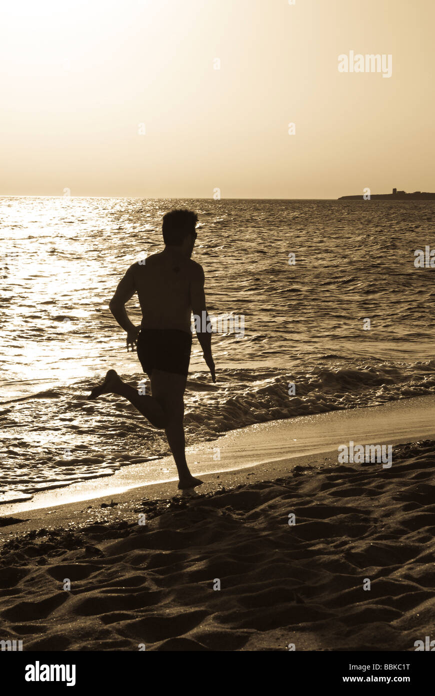man running on beach in san giovanni sardinia italy Stock Photo - Alamy