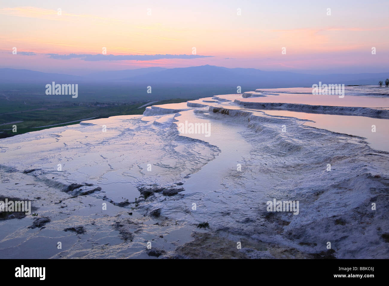 Sunset reflected in the white pools of Pamukkale in Turkey Stock Photo ...