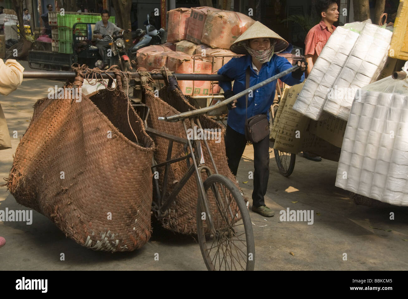 Vietnamese workers transporting goods at the border crossing in Hekou ...