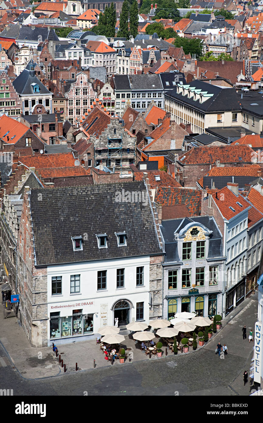 People in street and at pavement bar with rooftops of Ghent Belgium ...