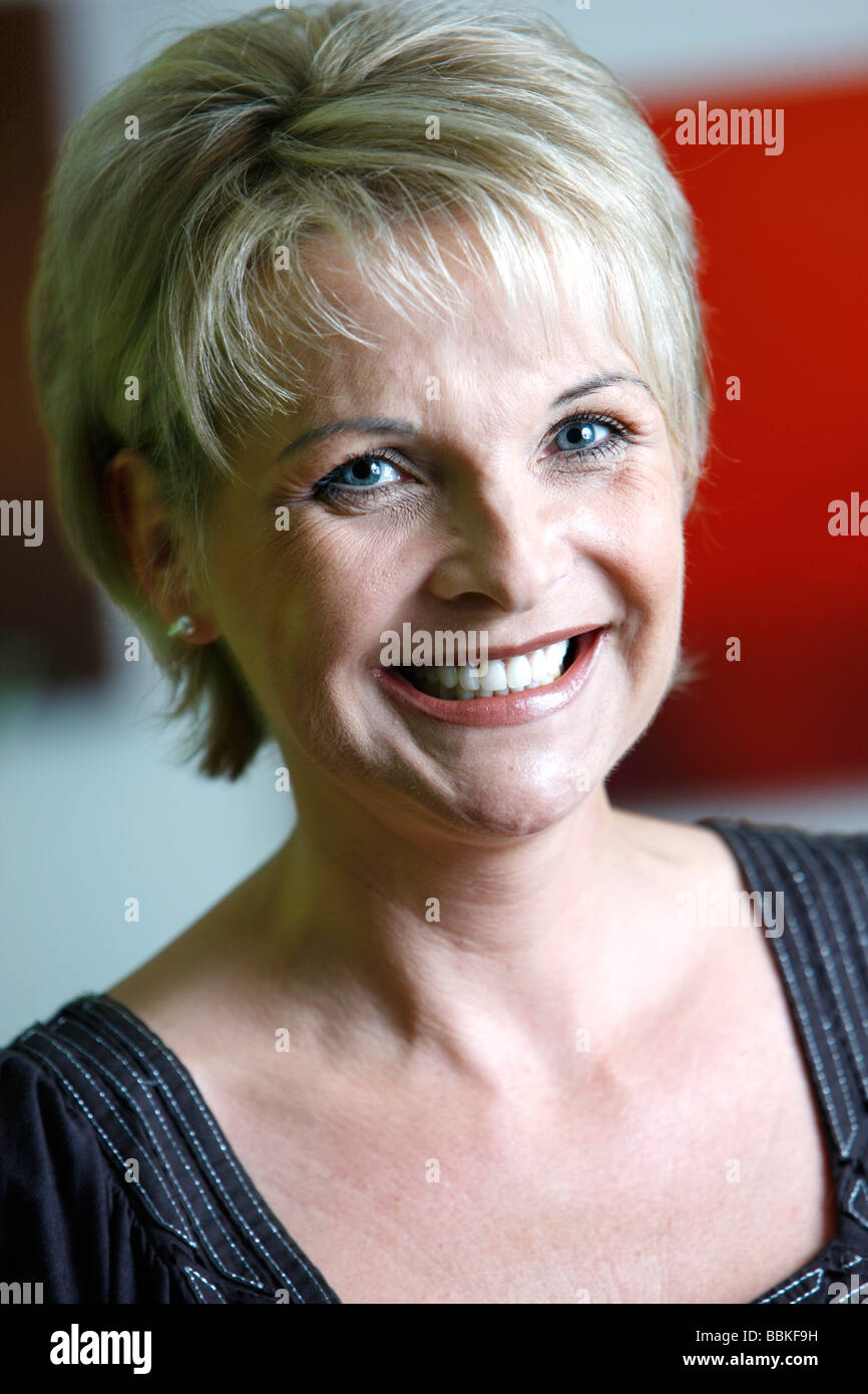 Woman 40 45 years old Smiling into the camera in a private environment ...