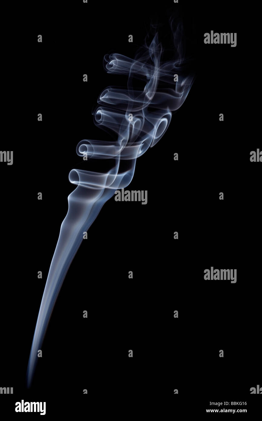 Curls of smoke given off by the slow-burning of an incense stick ...