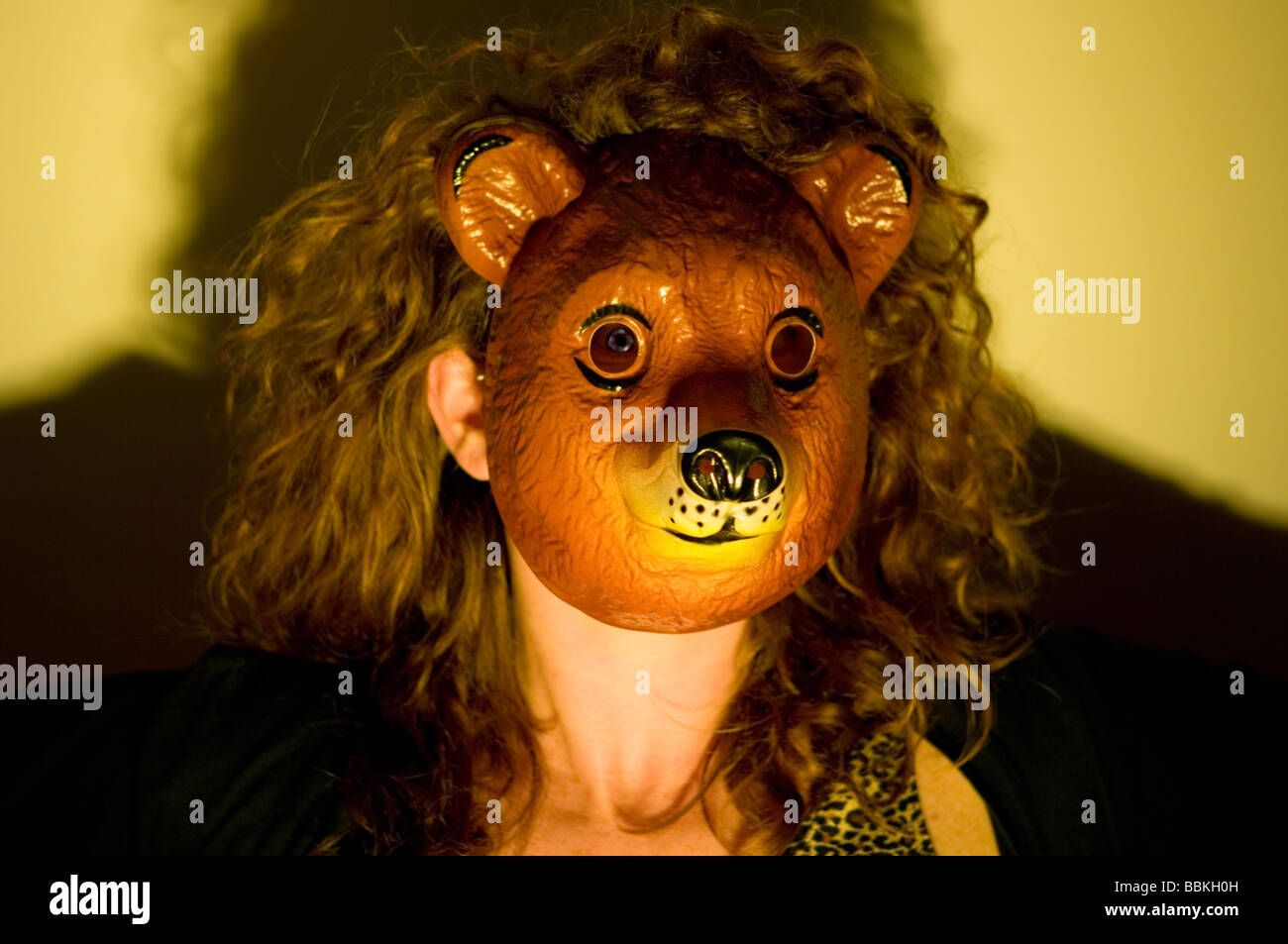 Woman as bear with mask and shadow Stock Photo - Alamy