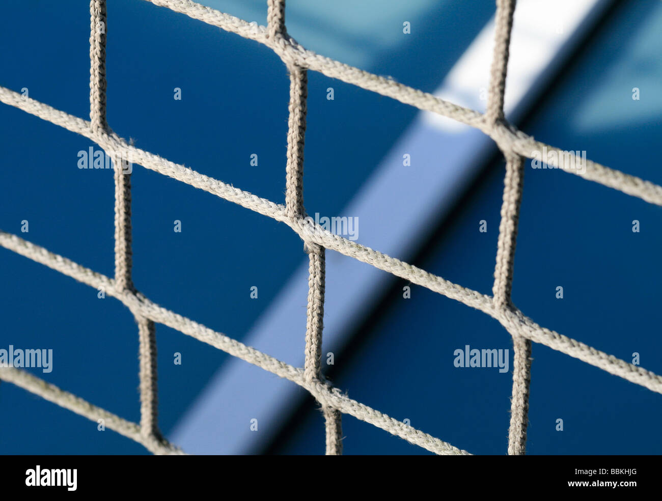 Netting against blue background Stock Photo - Alamy