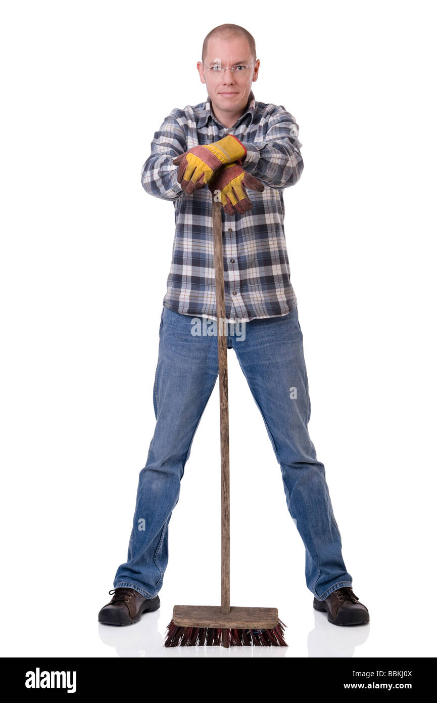 Full isolated studio picture from a young worker with a broom Stock ...