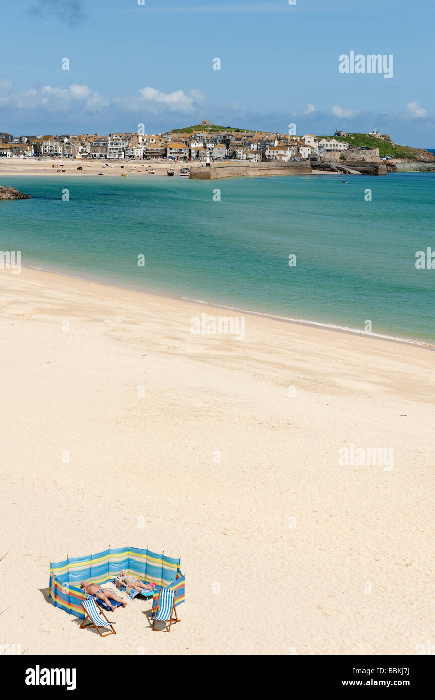 Two sunbathers share an empty Porthminster beach in St Ives, Cornwall ...